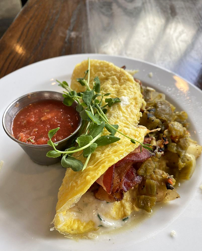 This isn't just an omelet&mdash;it's a love letter to breakfast, folded around bacon and vegetables with a side of salsa that makes your standard morning eggs seem like they're not even trying.