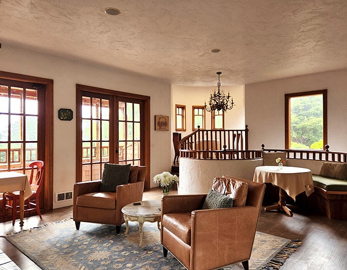 Thoughtfully arranged mantel decor blends European figurines with Pacific Northwest greenery. Coastal elegance without a hint of kitsch.