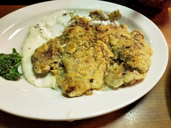 This chicken fried steak has achieved the golden ratio of crispy coating to tender meat, with gravy applied with the precision of a master painter.