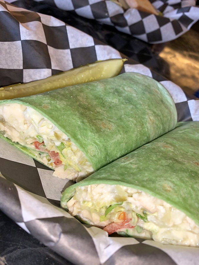 A wrap that refuses to be boring&mdash;vibrant green spinach tortilla hugging a chicken salad that clearly wasn't made by someone who hates their job.