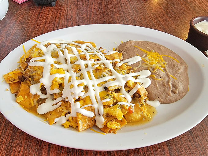 Chilaquiles with the perfect lattice of sour cream &ndash; breakfast that's both art and sustenance, like the Sistine Chapel of morning meals.