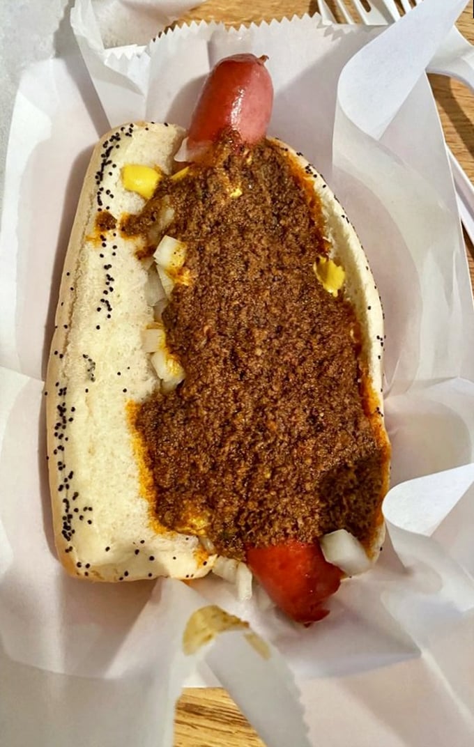 The Coney Island Chili Dog doesn't mess around&mdash;the homemade spiced beef chili blankets the dog like it's protecting something precious.