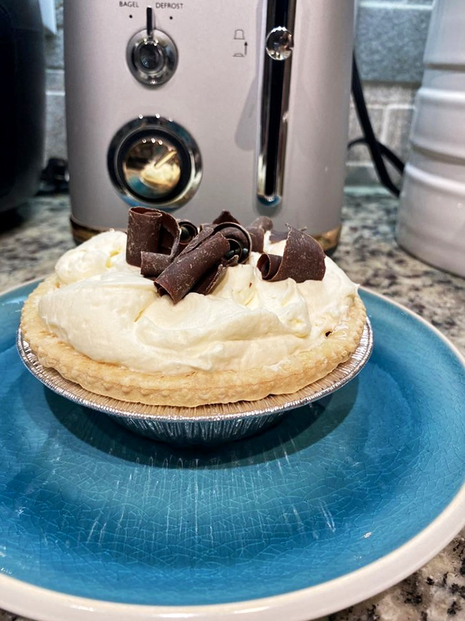 A cream pie so perfect it belongs in the dessert hall of fame. Those chocolate curls aren't just garnish—they're the crown jewels of pie royalty.
