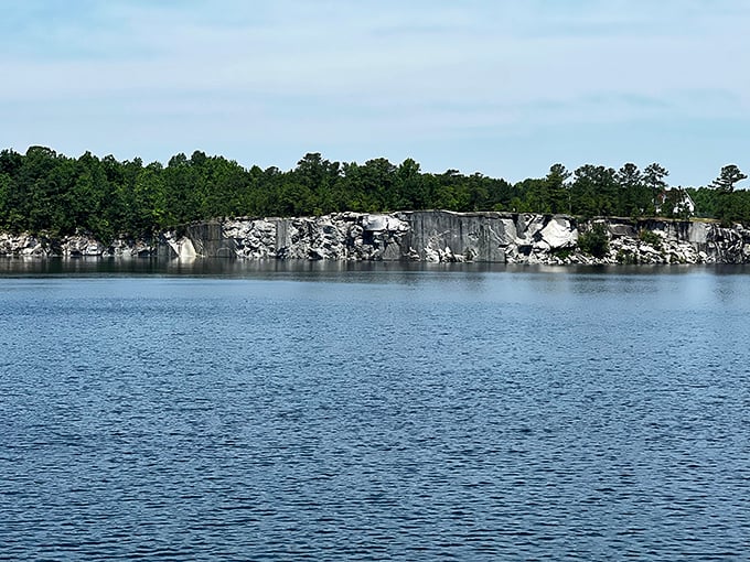 Nature's amphitheater. These impressive quarry walls frame the lake like a geological masterpiece, creating a dramatic backdrop for summer adventures.