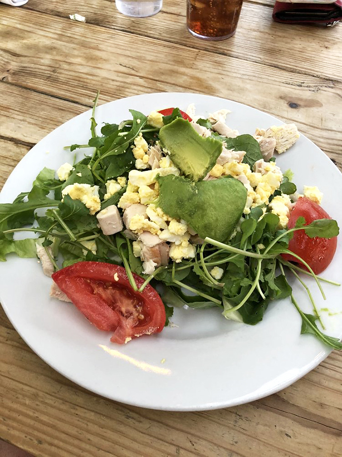 This isn't just a salad &ndash; it's a celebration of textures and colors featuring avocado hearts, fresh greens, and eggs that know their way around a plate.