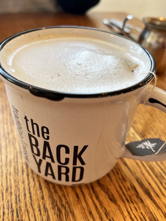 A proper coffee in a proper mug with The Backyard's logo—because life's too short for paper cups when you're enjoying something this good.