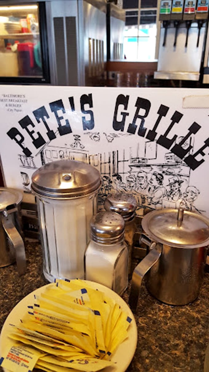 The diner essentials&mdash;sugar, salt, and a stack of yellow sweetener packets that have witnessed countless coffee conversations and breakfast debates.