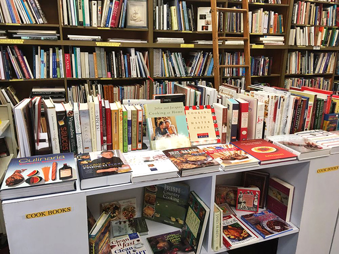 The cookbook section&mdash;where Julia Child's wisdom sits beside forgotten gelatin salad recipes from an era when Jell-O was considered haute cuisine.