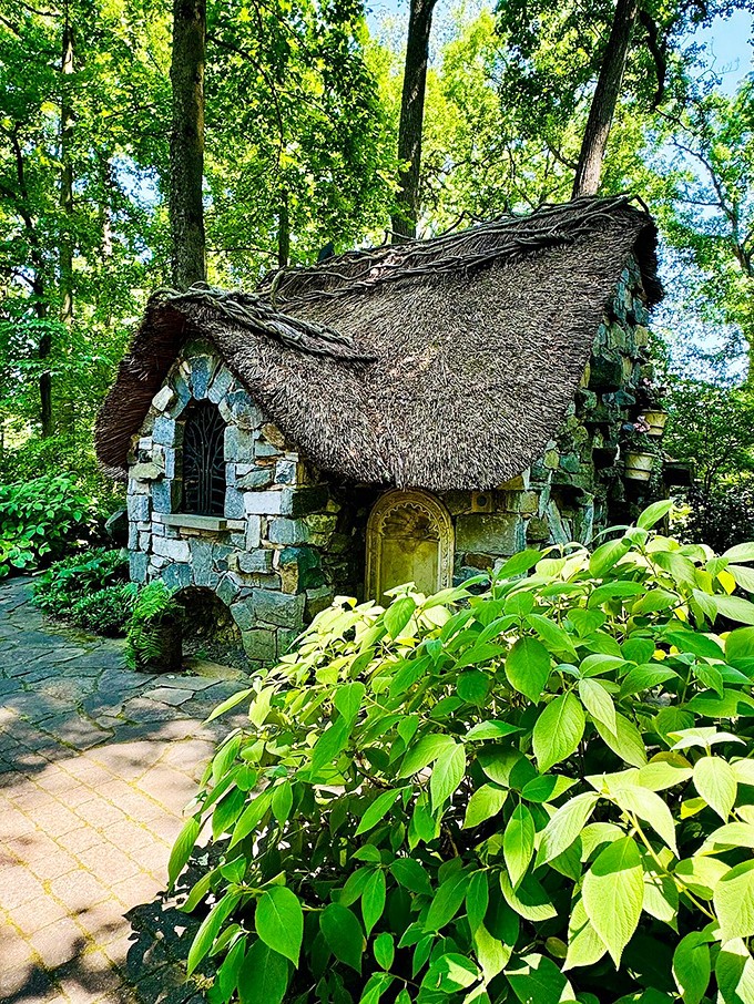 Not all fairy tales require castles. This enchanting stone cottage with its thatched roof looks like it was built by woodland creatures with exceptional architectural skills.