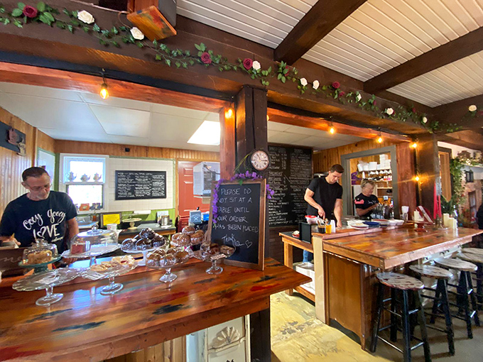 Behind every great cinnamon roll is a team of dedicated bakers. The wooden counter tells stories of countless batches of morning happiness.