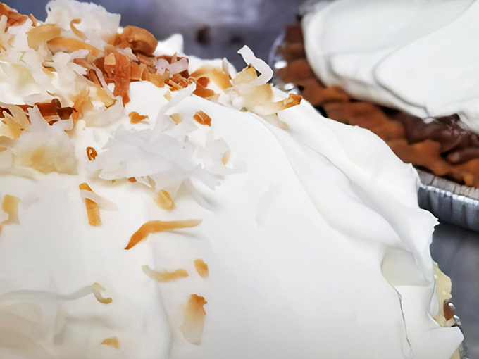 Coconut cream pie wearing its toasted crown like a tropical halo. One bite transports you straight to vacation mode, no plane ticket required.