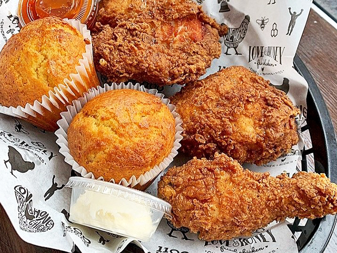 A tray of golden treasures with cornbread muffins standing by—this isn't a meal, it's a celebration on a plate.