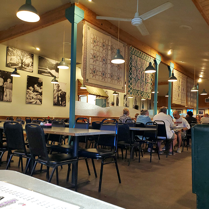 Handmade quilts hang like colorful flags above diners, adding warmth to a room already filled with the comfort of good food and conversation.