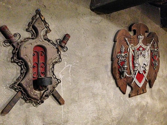 Medieval weaponry transformed into wall art&mdash;these decorative shields and crossed swords bring authentic medieval atmosphere to this unexpected Ohio treasure.