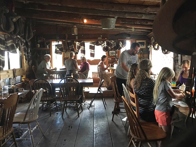 Pilgrims of all ages gather at wooden tables, united in the communal experience of a meal worth traveling for.