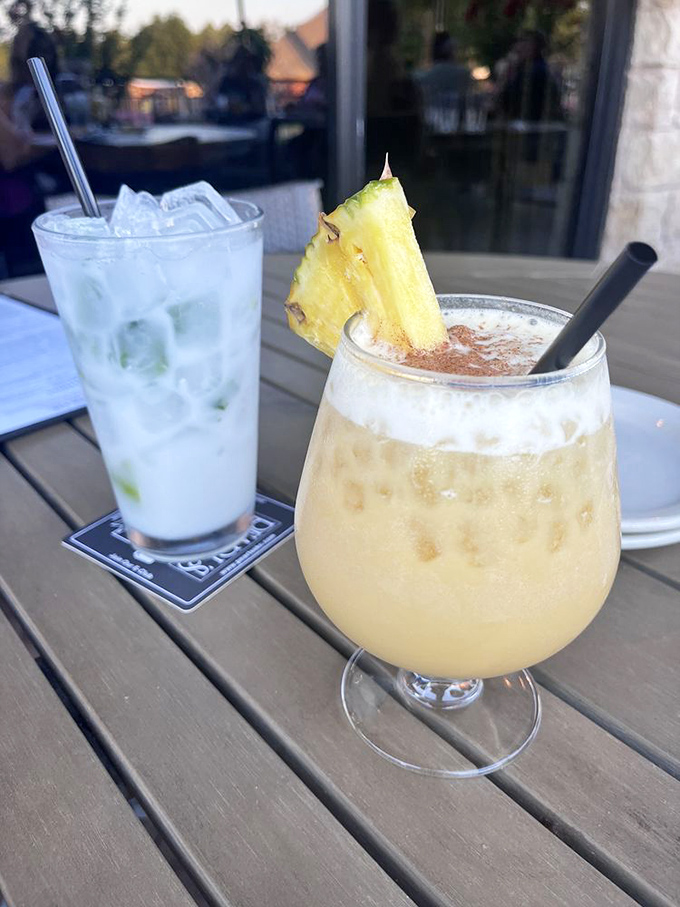 Tropical cocktails that make you forget you're hundreds of miles from any ocean. That pineapple garnish is working overtime.