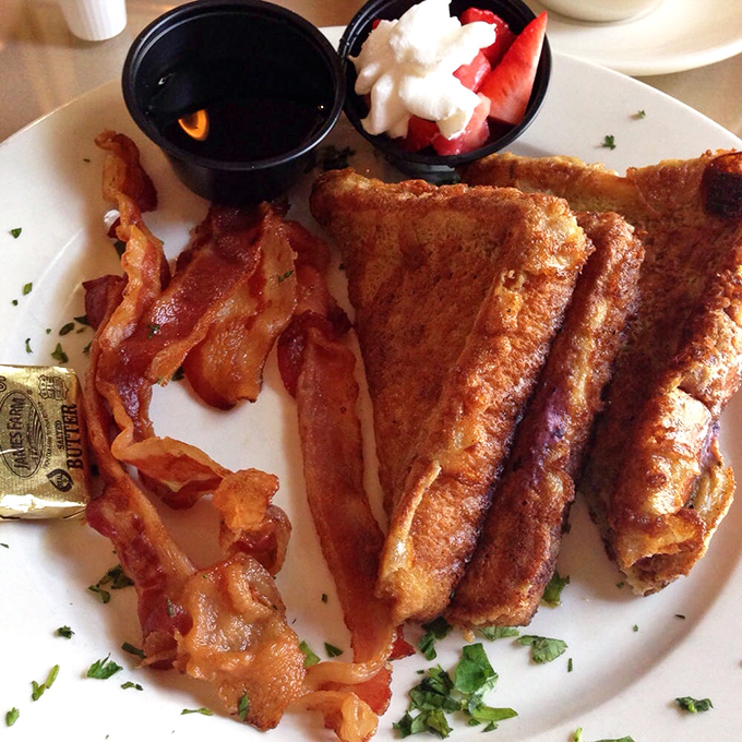 French toast that's achieved the perfect golden crust while maintaining a pillowy interior &mdash; flanked by bacon that's clearly living its best life.
