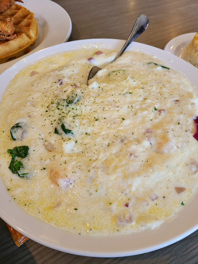 This isn't just any bowl of grits - it's a creamy canvas painted with savory bits, fresh herbs, and enough comfort to make grandma proud.