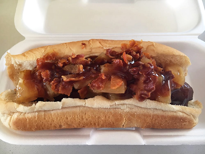 This smoky dog drowning in bacon and caramelized onions isn't a meal; it's a commitment, a relationship, a life choice.
