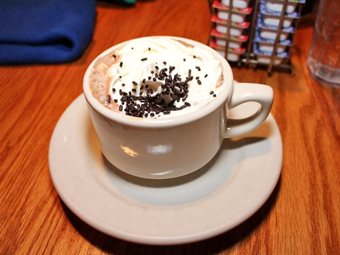 Not just hot chocolate, but a warm hug in a cup, complete with whipped cream hat and chocolate sprinkle confetti.
