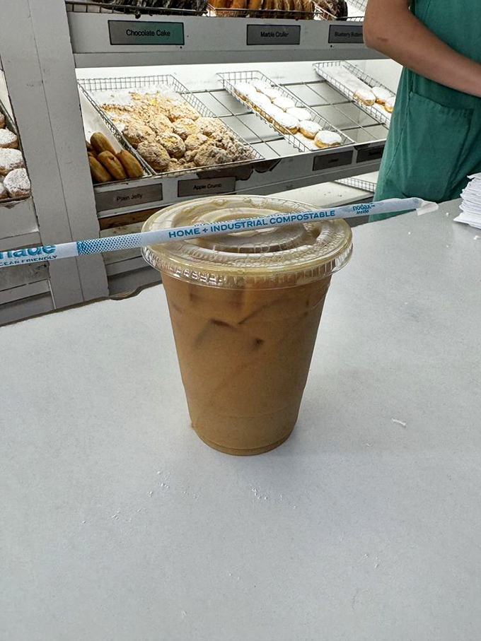 Iced coffee in a clear cup&mdash;simple, unpretentious, and exactly what you need to balance the sweet symphony of your donut selection.