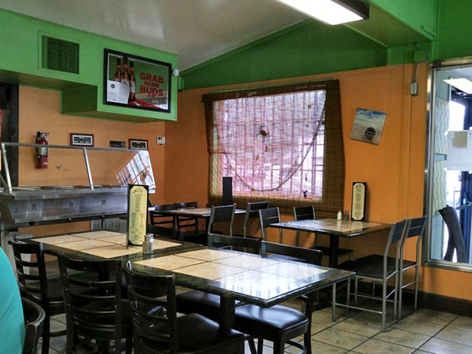 Bright orange and green walls create a fiesta atmosphere that perfectly matches the vibrant flavors coming from the kitchen.