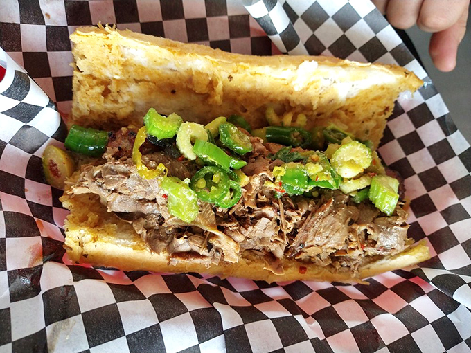 Look at that cross-section! Tender beef layered with bright green giardiniera – a sandwich that demands both your respect and your napkin collection.