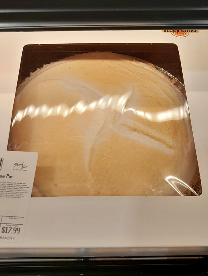 This meringue pie sits in its box like a cloud that somehow got captured and convinced to become dessert.