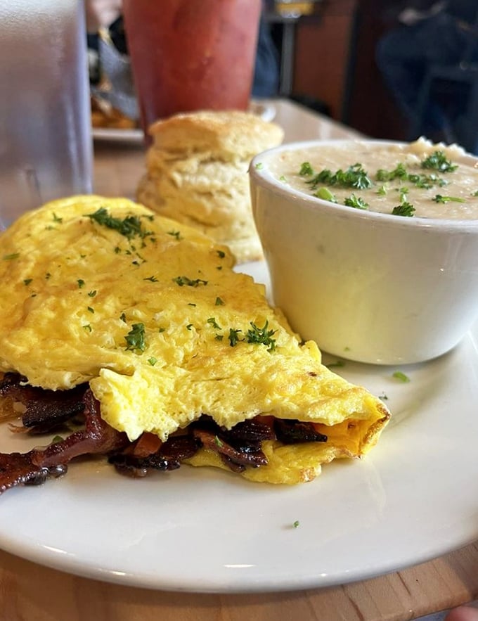 This isn't just an omelet&mdash;it's a golden envelope delivering a message of bacon love, with a side of creamy grits that whisper "stay awhile."