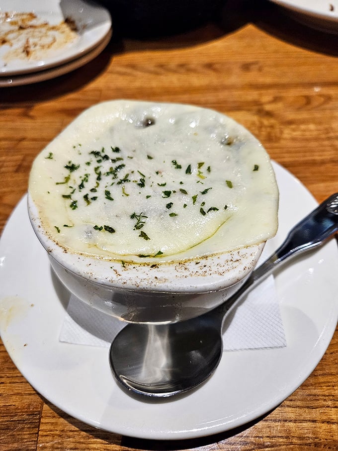 French onion soup done right&mdash;a bubbling cauldron of comfort topped with a golden cheese cap. Like a warm hug in a crock.