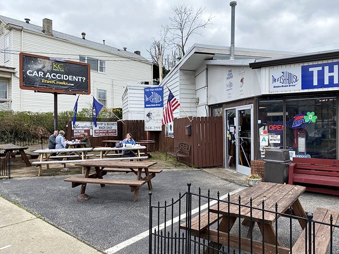 Picnic tables outside offer a casual alternative for sunny days. American flag waving, seafood waiting.
