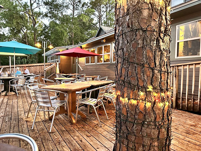 The outdoor deck features umbrella-shaded tables among towering pines – nature's air conditioning for your dining pleasure.
