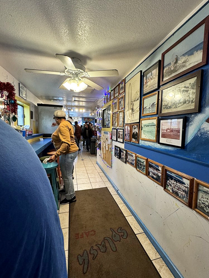 The wall of memories tells stories of ocean adventures and satisfied appetites. Each frame a testament to Splash Cafe's coastal legacy.