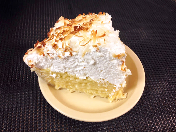 Coconut cream pie that reaches for the heavens like a trapeze artist. That toasted topping is the standing ovation it deserves.