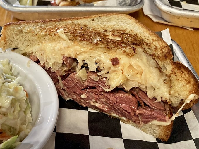 The cross-section reveals the Reuben's perfect meat-to-sauerkraut ratio. This sandwich doesn't just satisfy hunger—it obliterates it.
