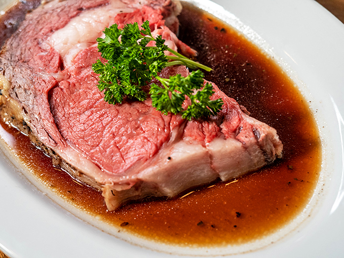 This prime rib isn't just dinner; it's a celebration with a parsley hat, swimming in a jus so rich it could buy a yacht.