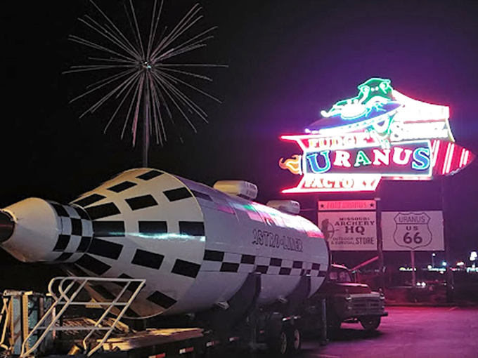 By night, the neon Uranus sign glows like a beacon for road-weary travelers. The rocket ship installation proves this isn't your average roadside stop&mdash;it's an otherworldly experience.