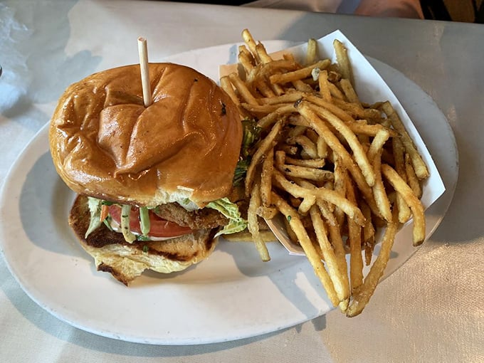 A towering sandwich flanked by golden fries &ndash; the kind of plate that makes neighboring tables point and ask, "What is THAT? I need it immediately."