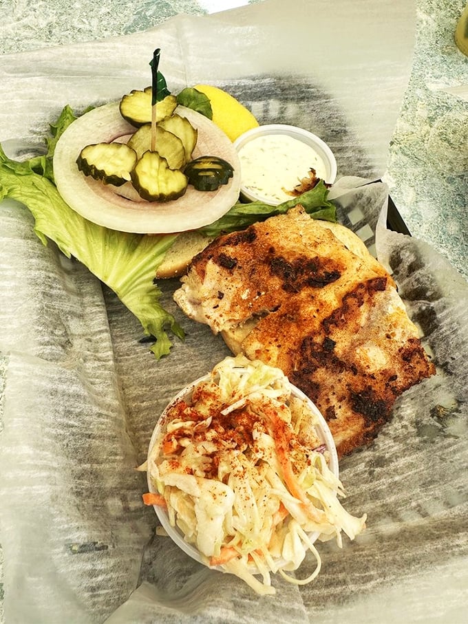 Blackened fish, crisp slaw, and fresh garnishes create the holy trinity of seafood sandwiches. Worth crossing state lines for.