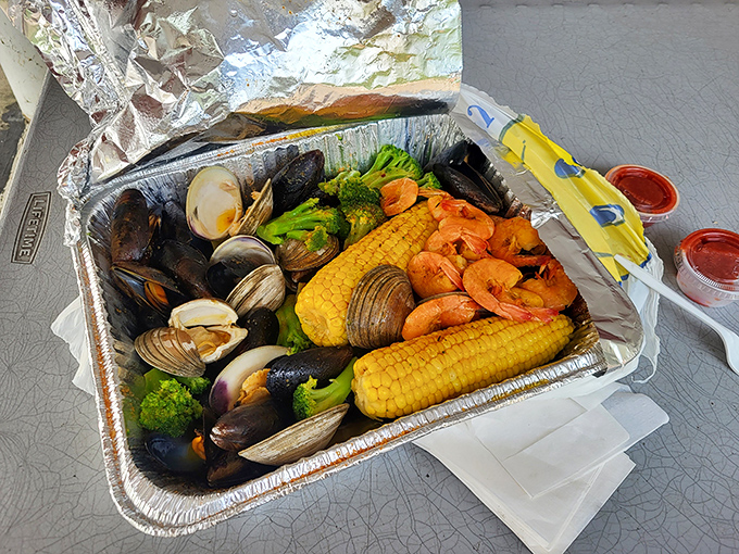 This aluminum tray holds an underwater reunion&mdash;mussels, clams, shrimp, and corn all bathing together in what must be the world's tastiest hot tub.