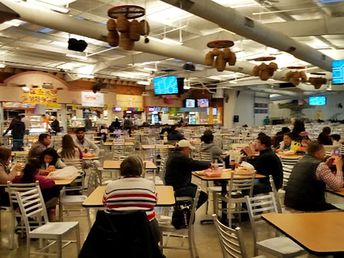 The market's dining area serves as both fuel station and social hub, where strangers become friends over shared plates of authentic delights.
