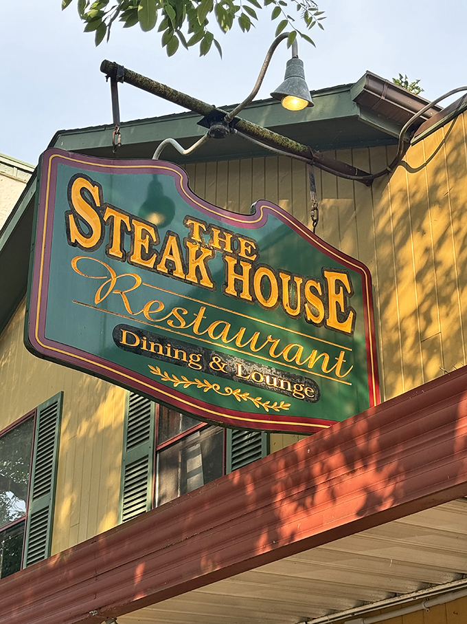 The vintage sign glows invitingly against the yellow clapboard – like a lighthouse guiding hungry souls to safe harbor.