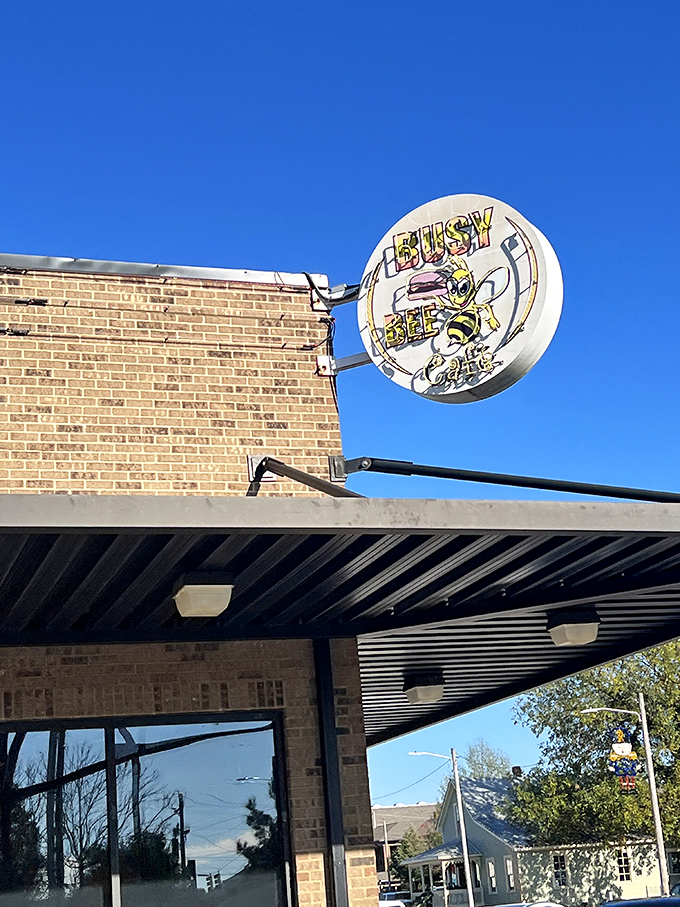 Against a perfect blue Alabama sky, the Busy Bee sign stands as a round yellow promise of good things to come.