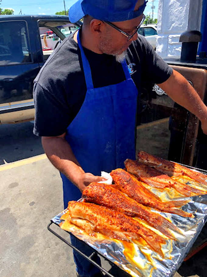 The master at work: seasoned fillets getting the royal treatment on this smoker, where flavor is king and patience is the prime minister.