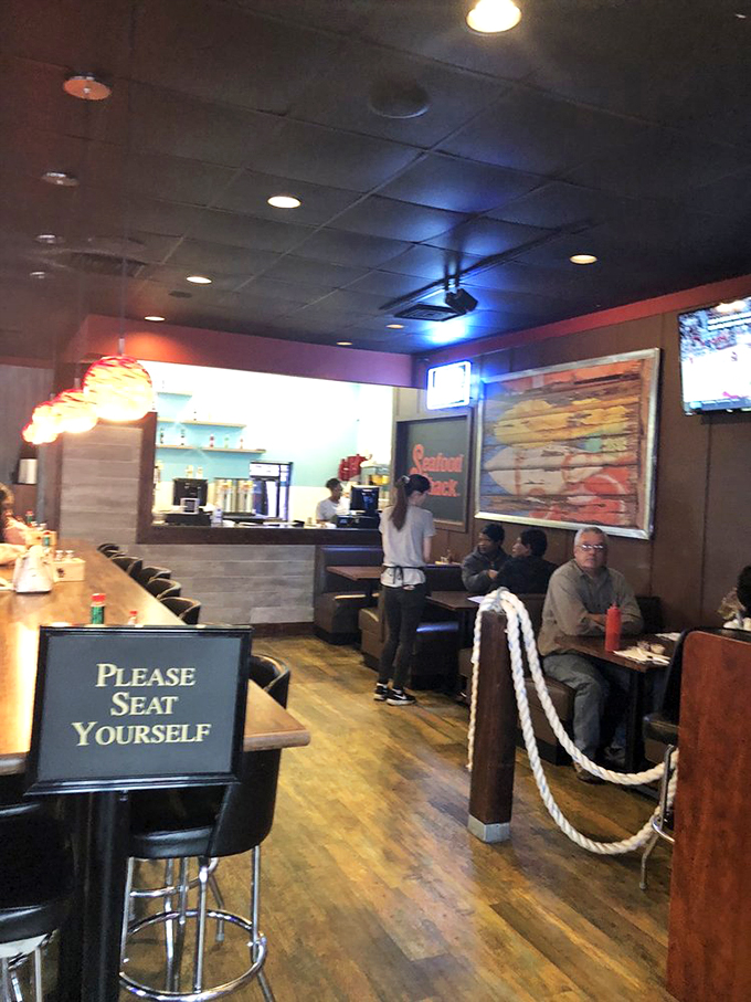 A glimpse into the warm, welcoming atmosphere where seafood dreams come true. That "Please Seat Yourself" sign might as well say "Make Yourself at Home."
