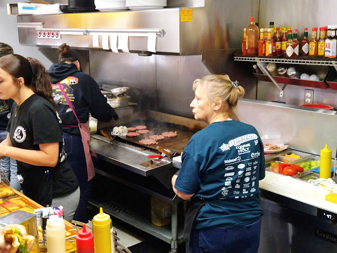 The choreography of the kitchen staff is mesmerizing&mdash;spatulas flying, burgers sizzling, and decades of diner wisdom in every practiced movement.