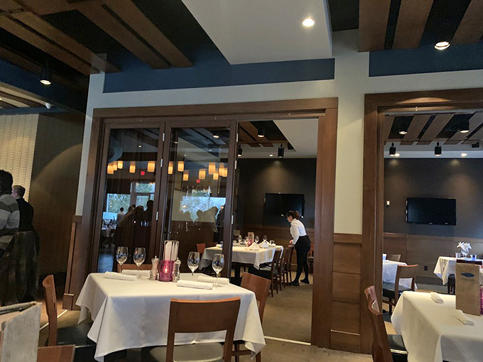 Modern art installations and pendant lighting create visual interest above, while culinary art commands attention below. 