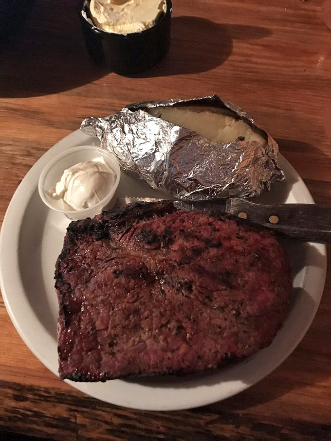 A steak so perfect it deserves its own area code. The baked potato in foil stands by like a faithful sidekick.