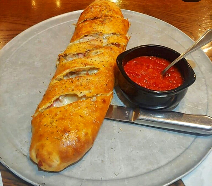 Not just a stromboli&mdash;a masterpiece of dough architecture protecting treasures of cheese and filling, with marinara standing guard.