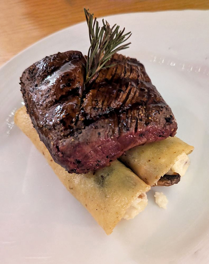 Tenderloin atop enchiladas—the culinary equivalent of a perfect marriage, where neither partner outshines the other but both are elevated together.